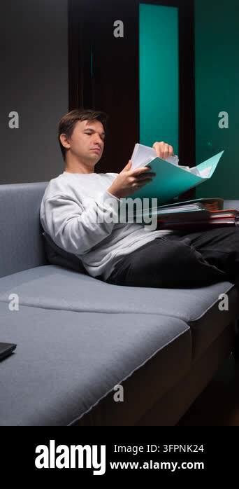 Vertical Video Young Man Analyzing Important Work Documents And Folders