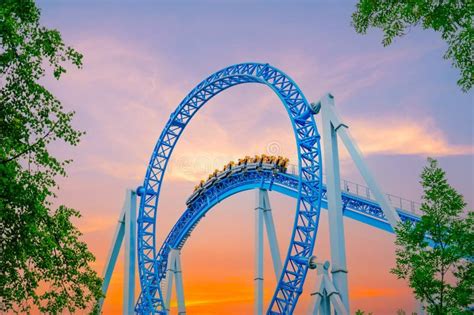 roller coaster cart and people riding it goes through a loop upside