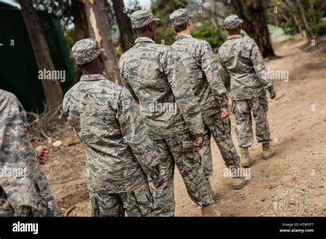 Group Of Military Soldiers In A Training Session At Boot Camp Stock
