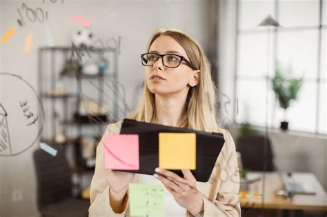 Premium Photo Businesswoman Using Tablet While Analyzing Graph At Office