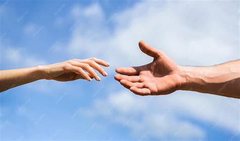 Premium Photo Hands Of Man And Woman On Blue Sky Background Lending A
