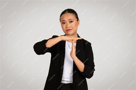 premium photo asian businesswoman in a black suit making a timeout