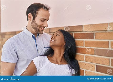 Man And Woman Interracial Couple Standing Together At Street Stock