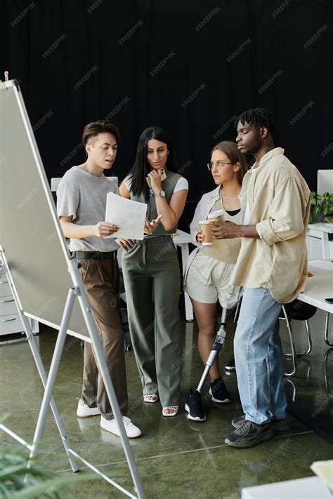 Premium Photo Startup Team Brainstorming Around Whiteboard In Modern Office