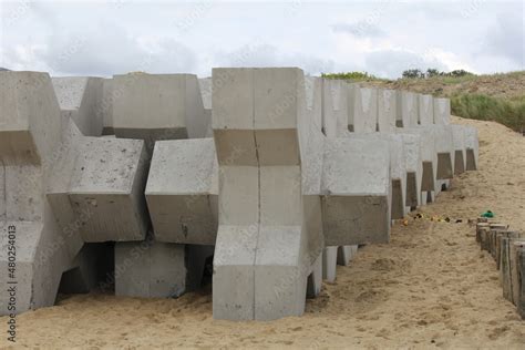 Rows Of Big Concrete Blocs In X Shape At The Beach In Cadzand At The Dutch Coast That Are Used