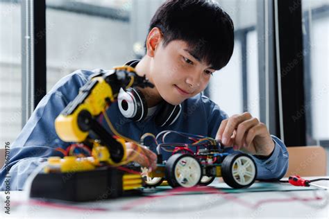 Asian Teenager Doing Robot Project In Science Classroom Technology Of Robotics Programing And