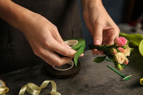 Premium Photo Female Hands Making Beautiful Flower Composition In Floral Shop