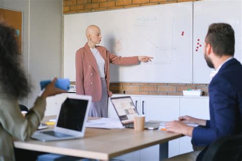 Premium Photo A Man Pointing At A Whiteboard With A Graph On It