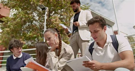 Students Solve Individual Tasks In Outdoor Class As Professor Watches