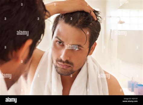 Man Looking At Self In Mirror Stock Photo Alamy