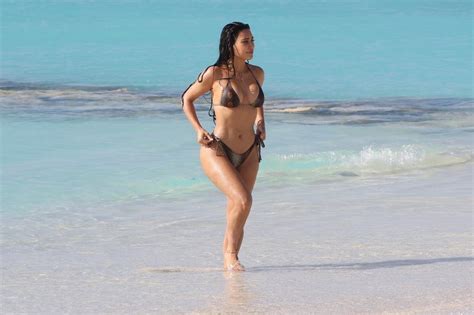 Kim and Khloé Kardashian wear sexy matching snakeskin swimsuits during