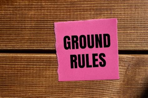 Premium Photo Ground Rules Message Written On Ripped Torn Pink Paper Piece With Wooden