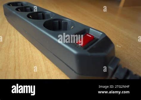 Insert Plug Into Extension Cord Socket By Pressing Red Push Button Switch With Your Finger