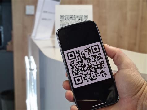 Premium Photo Woman Hand Uses Mobile Phone Application To Scan Qr Codes In Stores That Accept