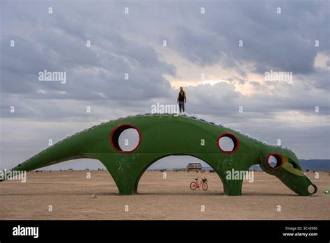 Green Dinosaur Art Installation At Burning Man In Nevada Desert Stock
