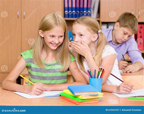 Girls Sharing Secrets In Classroom Royalty Free Stock Image 60176758