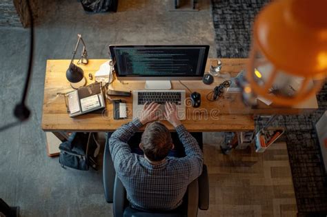 Top View Of Software Developer Working On A Laptop At Home Stock