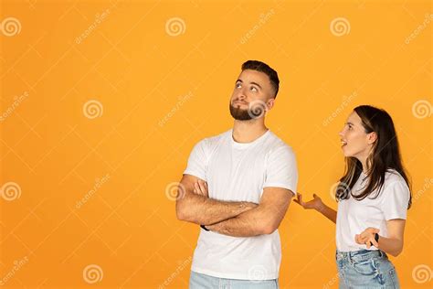 Skeptical Man With Crossed Arms Looking Unconvinced Beside A Talking