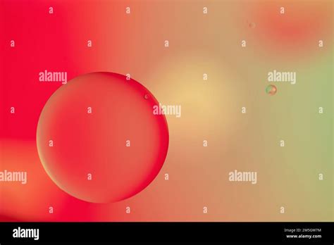 Colourful Light Diffraction Patterns Formed By Oil Droplets Floating On Water Above A Coloured