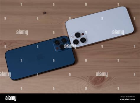IPhone 13 Pro Max In Silver And IPhone 12 Pro Max In Pacific Blue Stock Photo Alamy