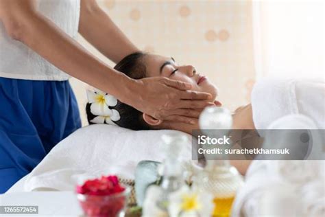 Young Asian Woman Getting Massage In The Spa Salon Enjoying And