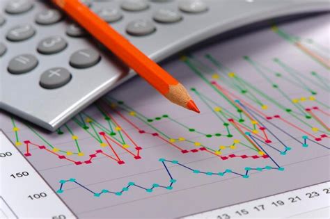Premium Photo Close Up Of Colored Pencil And Calculator On Graph