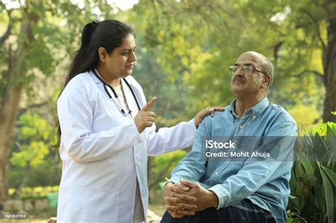 낮에 도시 공원의 야외에서 지팡이를 들고 노인 환자를 진찰하는 여성 의사 25 29세에 대한 스톡 사진 및 기타 이미지 25 29세 2명 60 64세 Istock