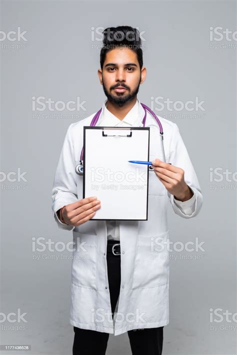 잘 생긴 인도 남성 건강 관리 전문가 또는 의사 또는 간호사의 클로즈업 초상화 클립 보드를 들고 텍스트에 대 한 공간을 보여주는