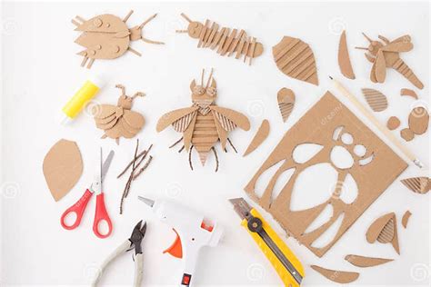 Handmade Cardboard Insect Crafts With Crafting Tools On White