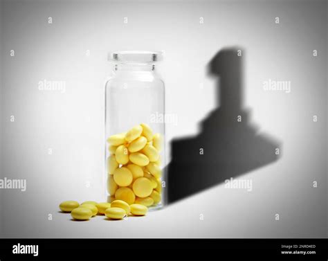 Doping Concept Yellow Pills In Glass Bottle With First Place Shadow On Light Background Stock