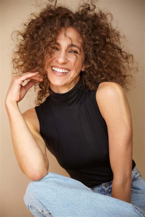 Download Curly Haired Woman Smiling Casually Wallpaper Wallpapers Com