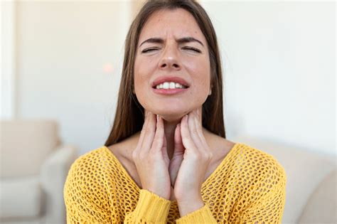 Close Up Of Young Woman Rubbing Her Inflamed Tonsils Tonsilitis Problem