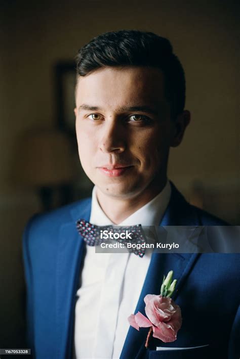 파란색 정장에 세련된 행복 한 신랑 나비 넥타이와 부토니에 르 포즈와 호텔 방에서 창 근처 미소 결혼식 전 아침 준비 결혼식에 대한 스톡 사진 및 기타 이미지 Istock