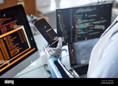 Closeup Image Of Software Developer With Prosthetic Arm Testing Code On