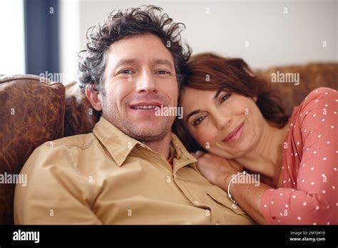 Its A Lazy Weekend And We Love It A Husband And Wife Relaxing Together On The Sofa At Home
