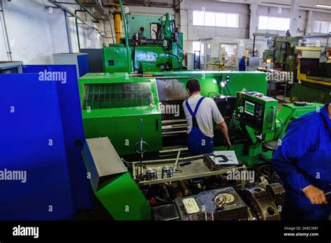 Factory Engineer Adjusting Operation Parameters Of Cnc Lathe Machine