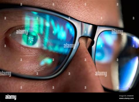 Trader Looking At Computer Screen Analyzing Trading Chart Reflecting In