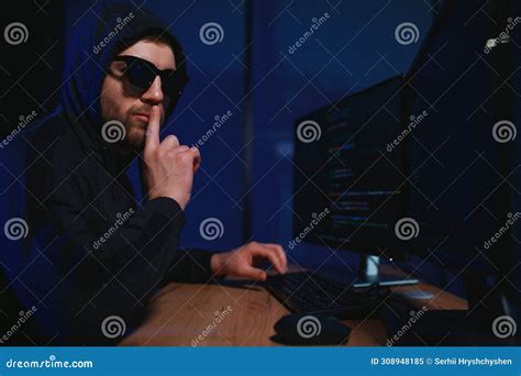 Hacker Sitting At Desk In Dark Atmosphere A Computer Programmer Or Hacker Anonymous Computer