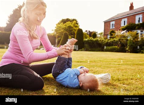Mother Playing In Garden With Baby Son Stock Photo Alamy