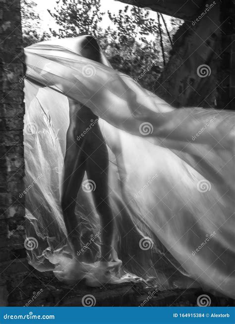 Slender Nude Girl Covered By A Cellophane Film Through Which Only Her