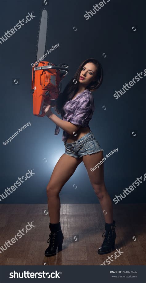 Image Sexy Model Promotes Modern Chainsaw Stock Photo