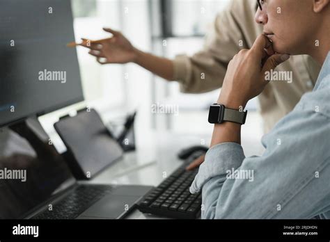 Two Developer Programmer Discussing To Checking Code On Monitor About