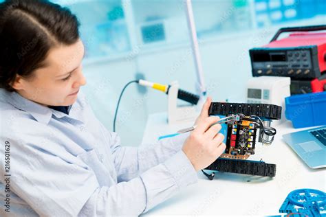 Student Girl In Electronics Laboratory Experiment With Microcontroller And Robot Cnc Module