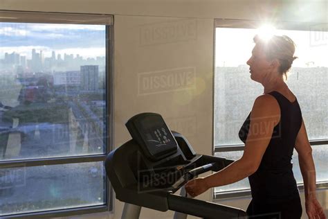 Woman Walking On Treadmill In Gym Facing City View Manila Philippines Royalty Free Stock