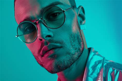 Fashion Male Model In Metallic Eyewear With Neon Teal Background Modern