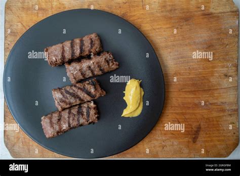 Traditional Romanian Grilled Minced Meat Mici Or Mititei On A Black