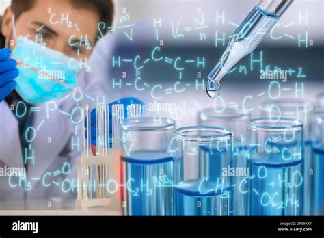 Scientist Working In Laboratory Dripping Reagent Into Test Tube And