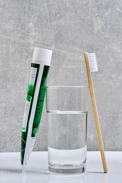 Premium Photo Tube Toothpaste Brush And Glass Water Gray Background