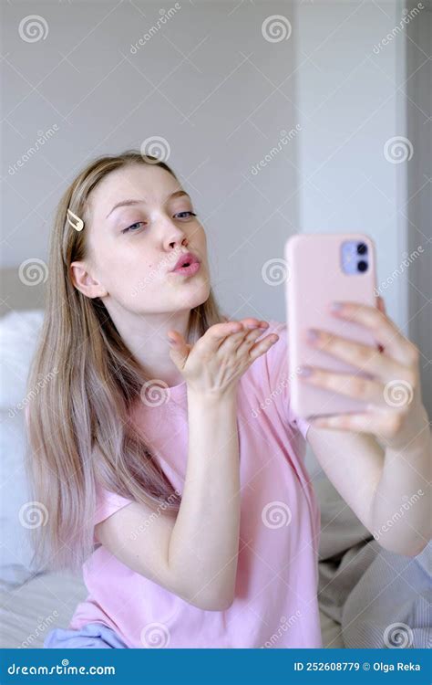 Cute Girl 15 18 Years Old Sitting On The Bed Makes A Selfie Stock