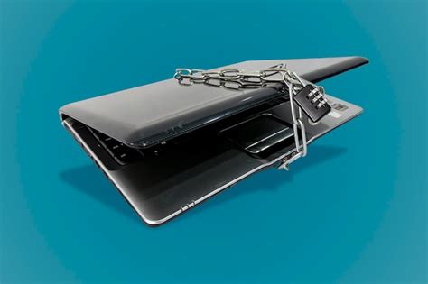 Premium Photo Notebook Computer Locked With Iron Chain And Key Concept For Data Protection And